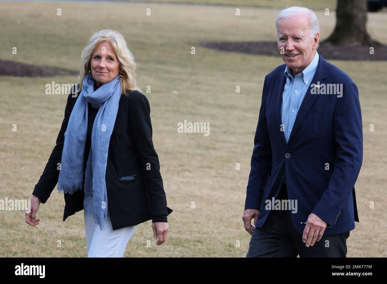 President Joe Biden and first lady Jill Biden walk on the South Lawn as ...