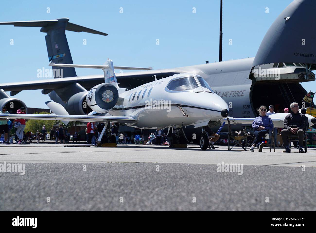 Two attendees sit in front of static displays at the Titans of Flight ...