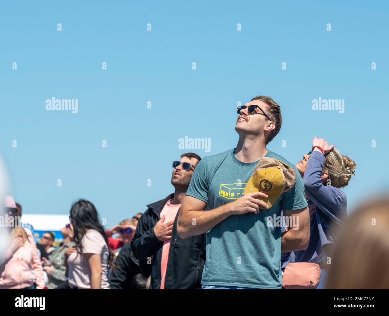 Attendees observe the national anthem at the Titans of Flight Air Expo ...