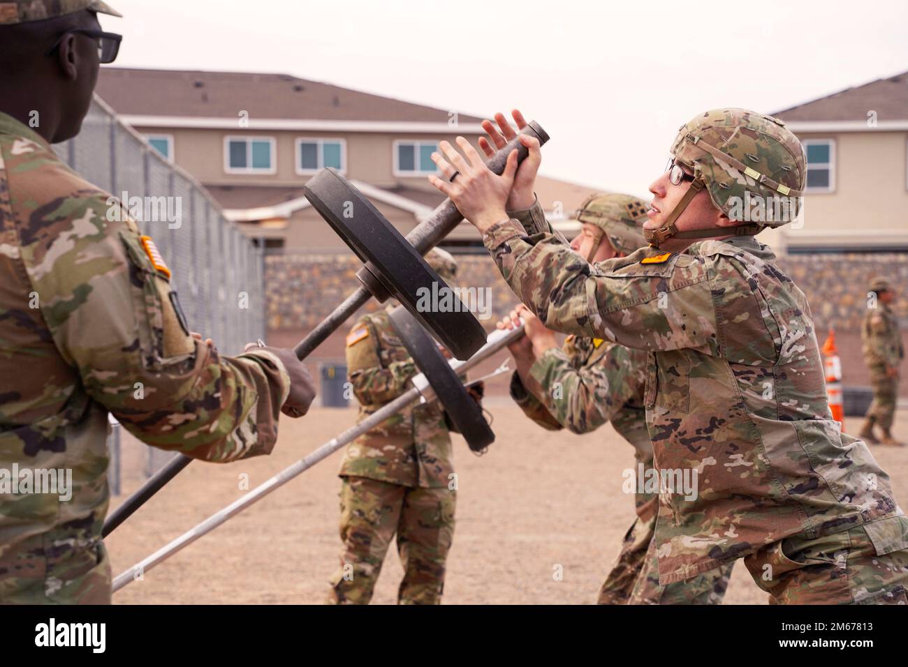 U.S. Soldiers complete the squat press at the first station during the ...