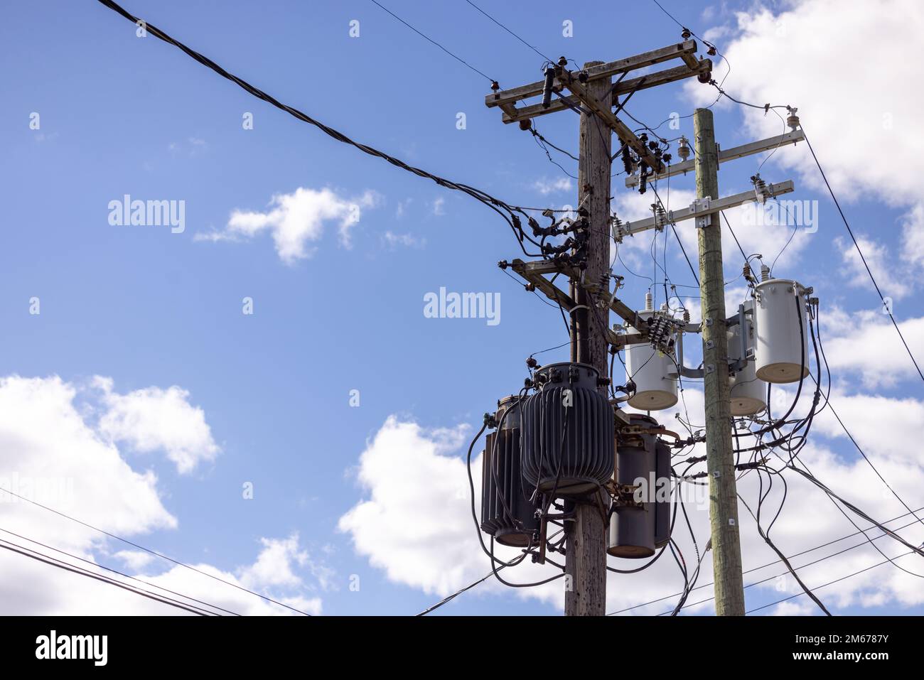 Utility pole against blue sky Stock Photo - Alamy