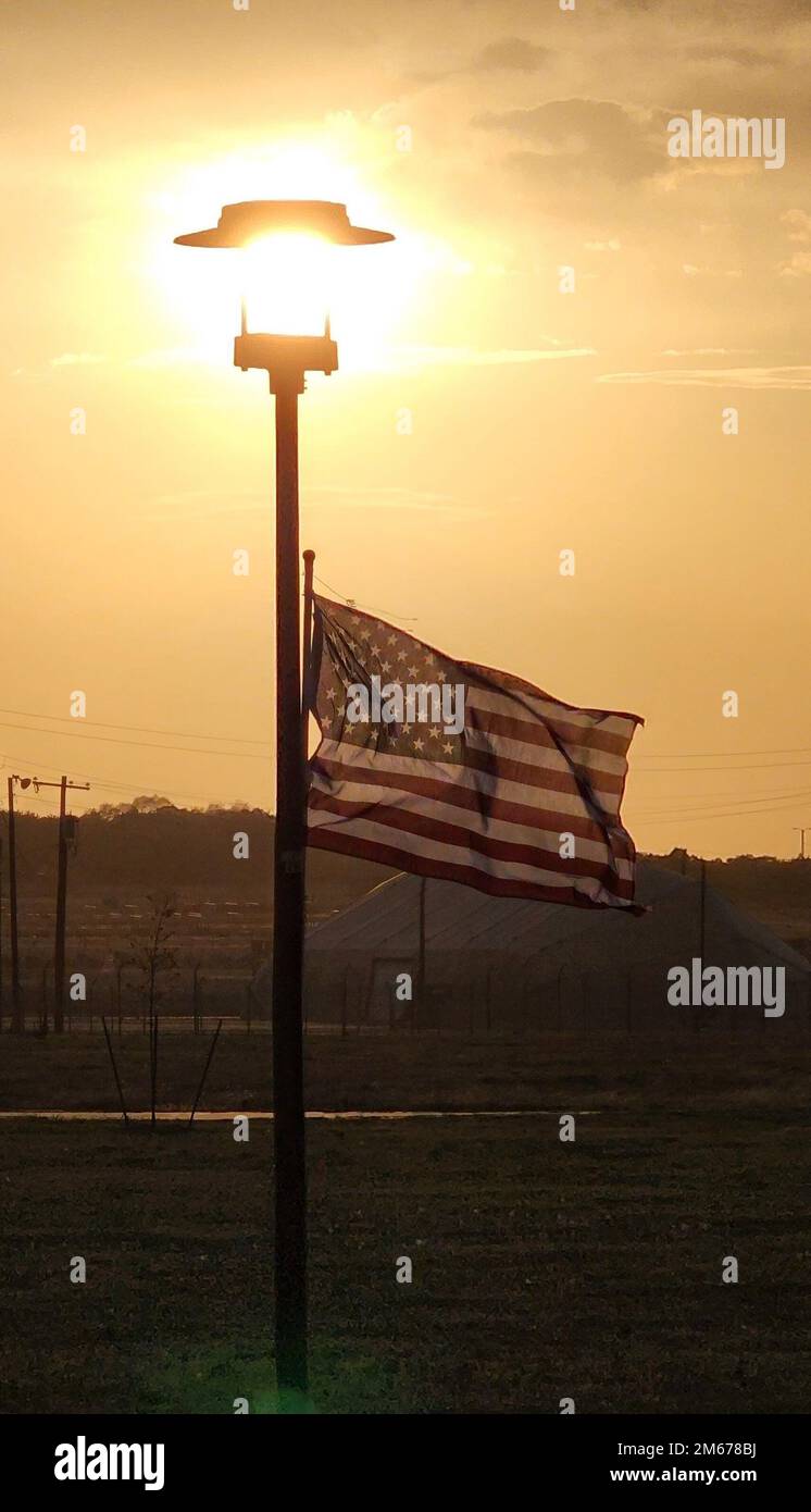 Following light rain, a sunset emerges and is captured through a stand ...
