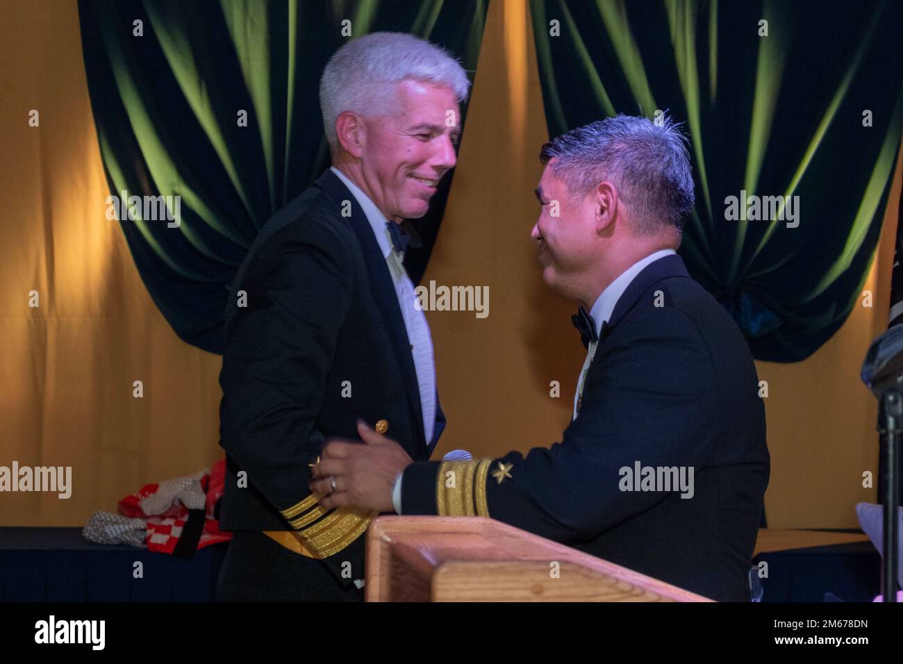 YOKOSUKA, Japan (April 10, 2022) Rear Adm. Butch Dollaga, Commander, Submarine Group 7, hands ...