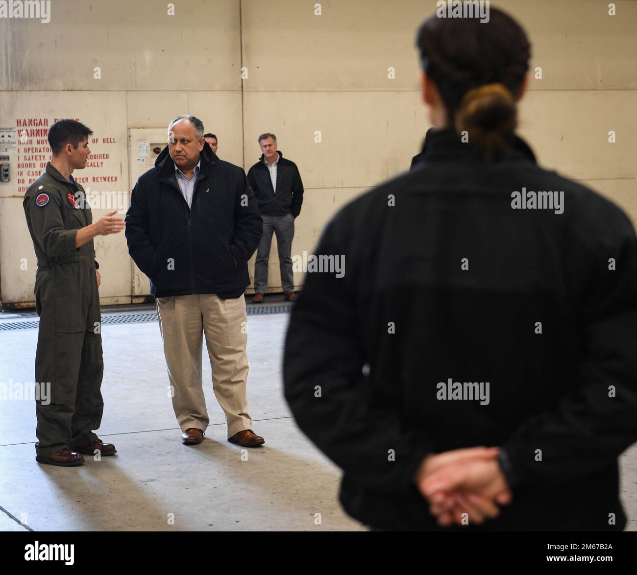 Secretary of the Navy Carlos Del Toro, center, speaks with Cmdr. Warren ...