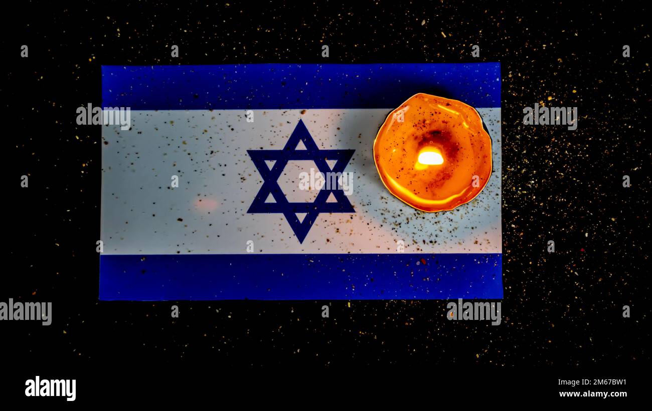 Israeli flag and burning candles above it, Holocaust memory day Stock ...