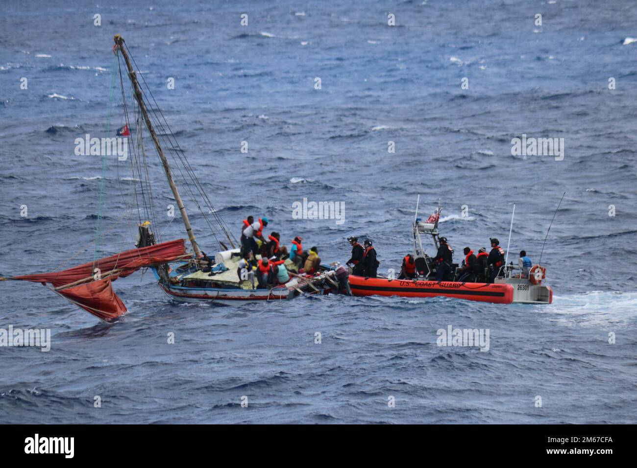Coast Guard Cutter Campbell's small boat crew rescuing people aboard a ...