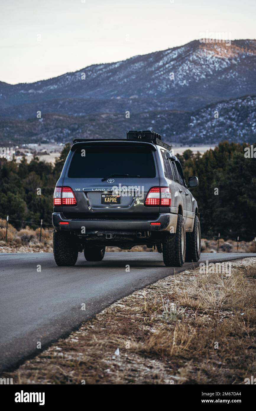 Rear Angle of a Land Cruiser 100 Series SUV overlooking a lake and ...