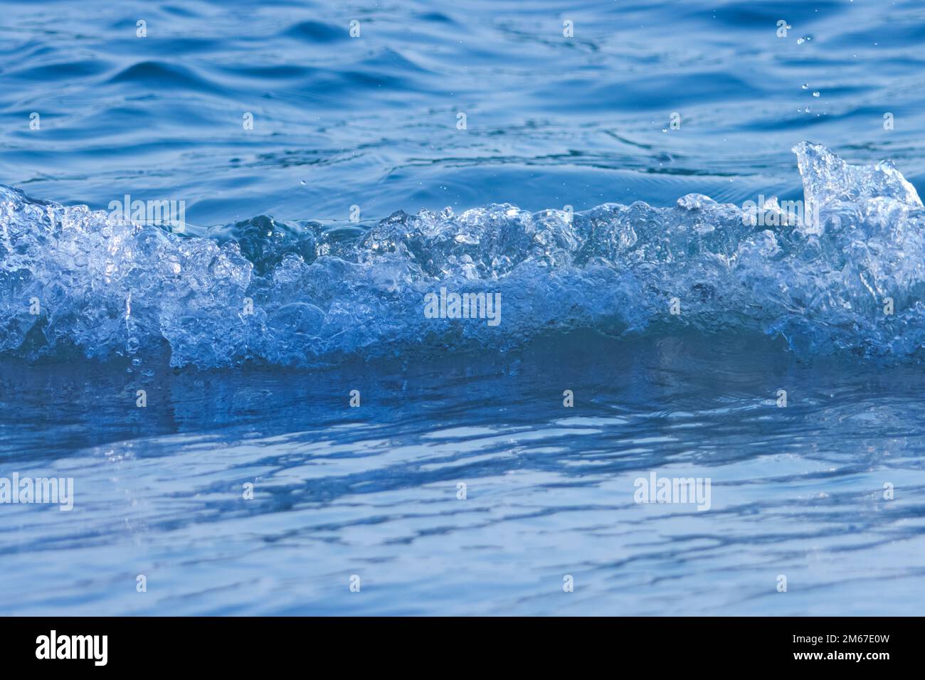 Ocean wave splashing Stock Photo - Alamy