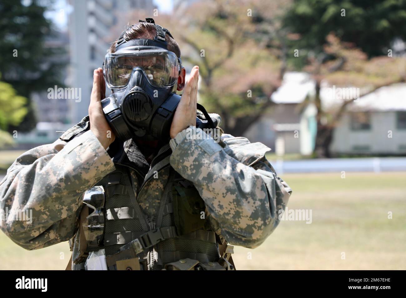 A U.S. Army Japan soldier dons his protective mask during chemical and ...