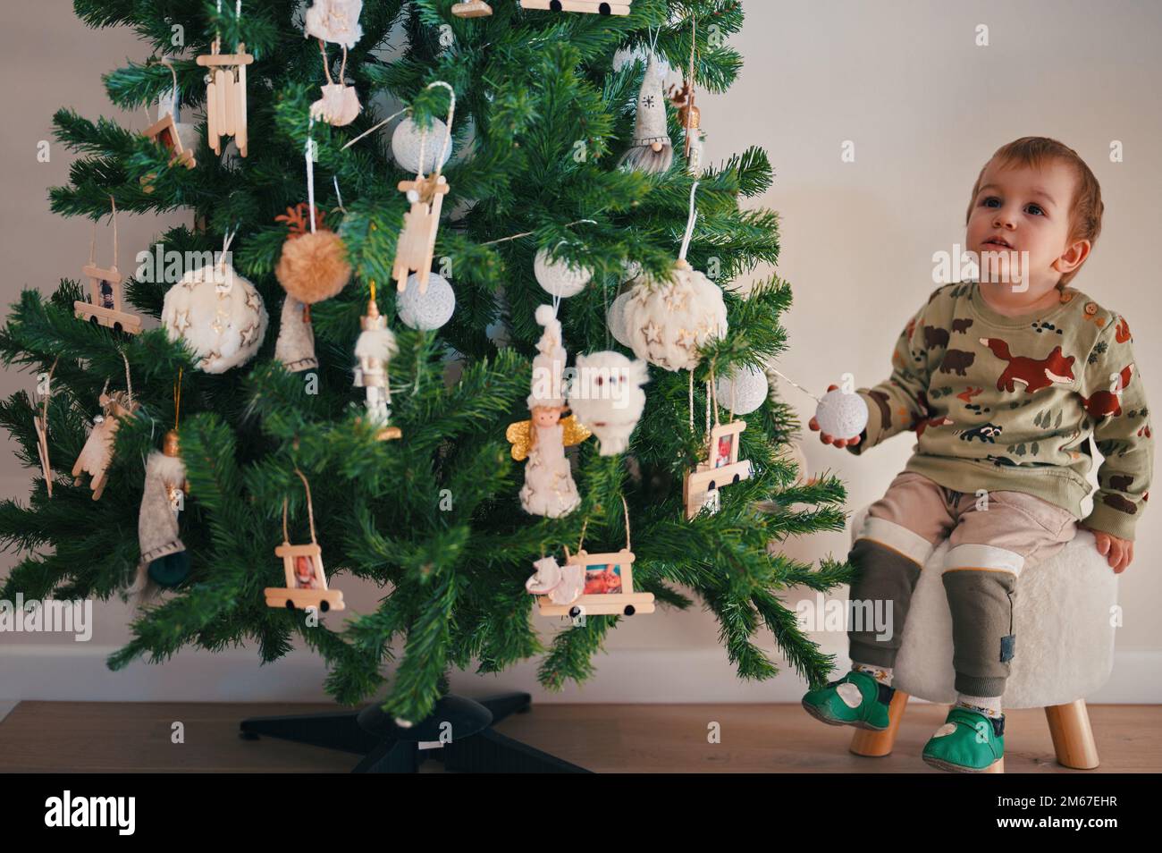Cute Little Toddler Sitting In Front Of Christmas Tree Stock Photo Alamy cute-little-toddler-sitting-in-front-of-christmas-tree-stock-photo-alamy