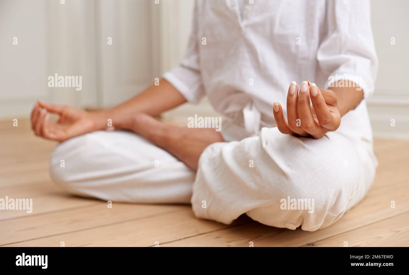 Stress free zone. a woman sitting in the lotus position during a yoga ...