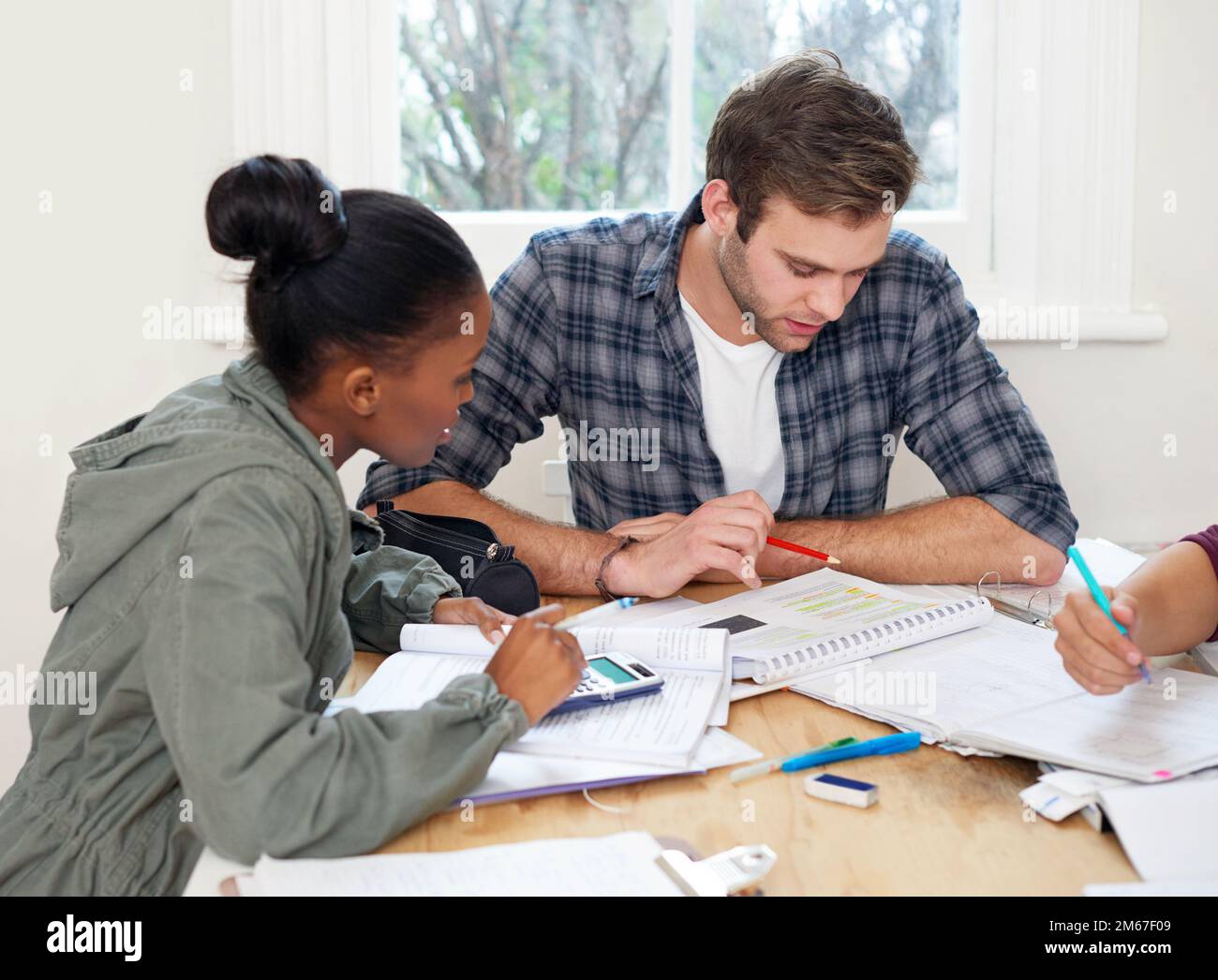 Getting ready for finals. three university students studying Stock ...