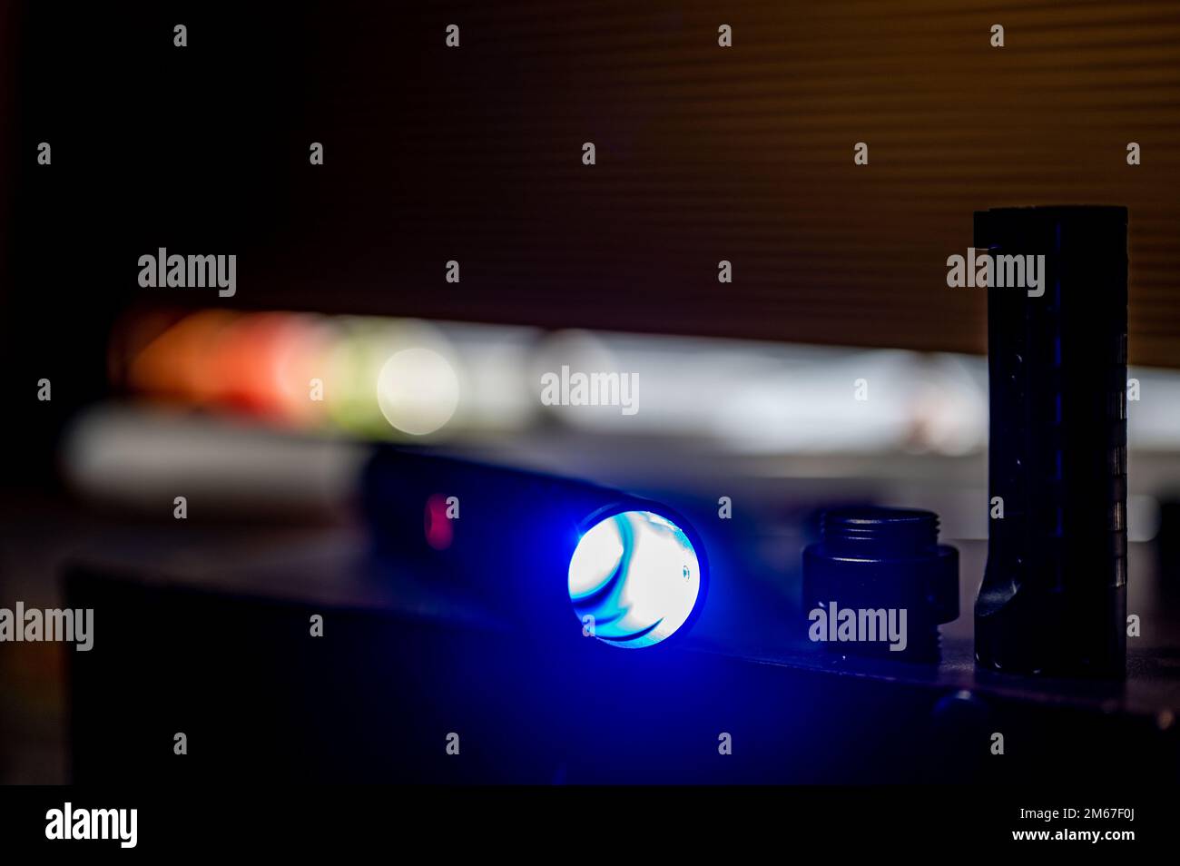 Assorted parts to build a laser sword from a kit with a hilt, neon ...