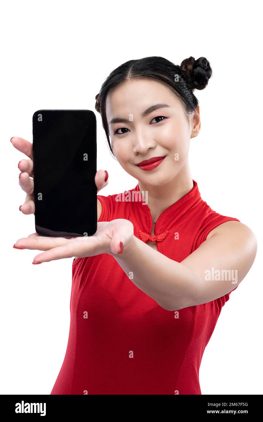 Asian Chinese woman in a cheongsam dress showing an empty mobile phone ...