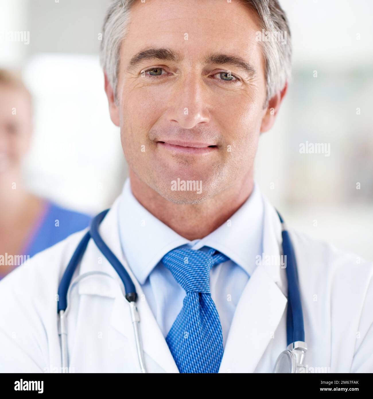 He has a calming effect on patients. Portrait of a male doctor with a ...