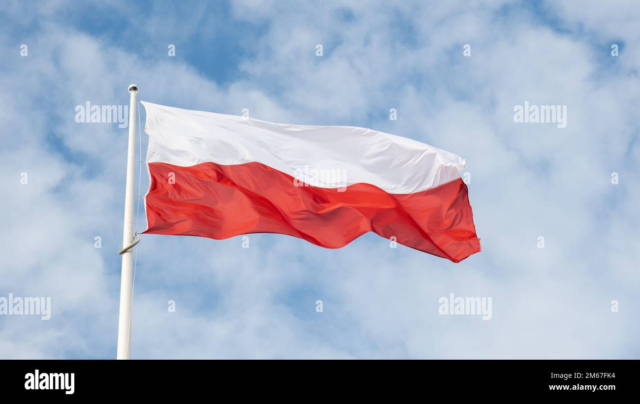 Flag of Poland waving at wind against beautiful blue sky. Polish flag ...