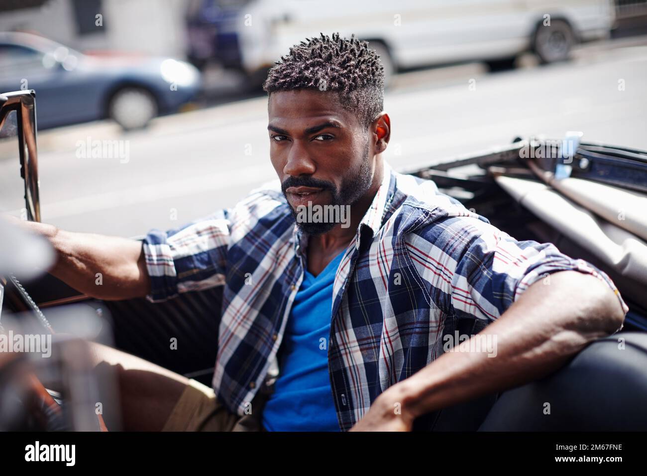 The cars we drive say a lot about us. A handsome young man driving in ...