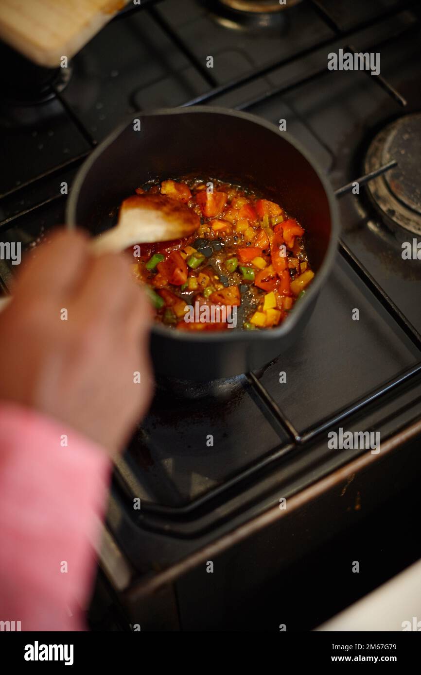 Mouthwatering meal. a man cooking a mixture of chopped vegetables on ...