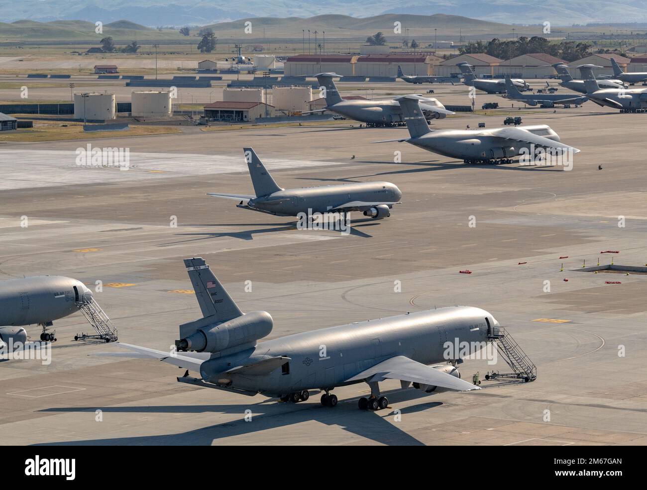 A U.S. Air Force KC-46A Pegasus, top center, rolls past a KC-10 ...