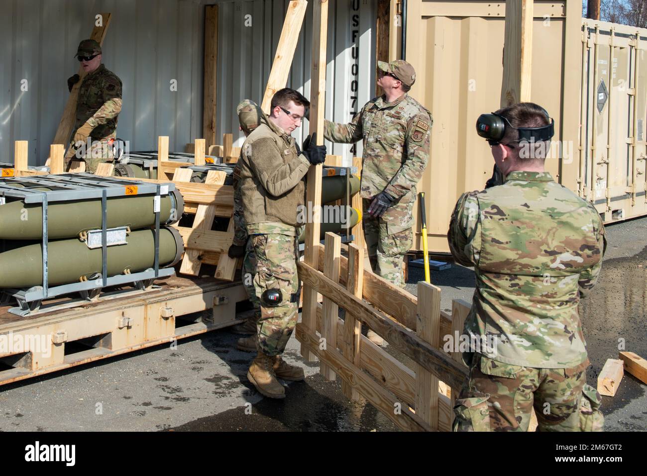 U.S. Airmen with the 3rd Munitions Squadron remove bracing used to ...