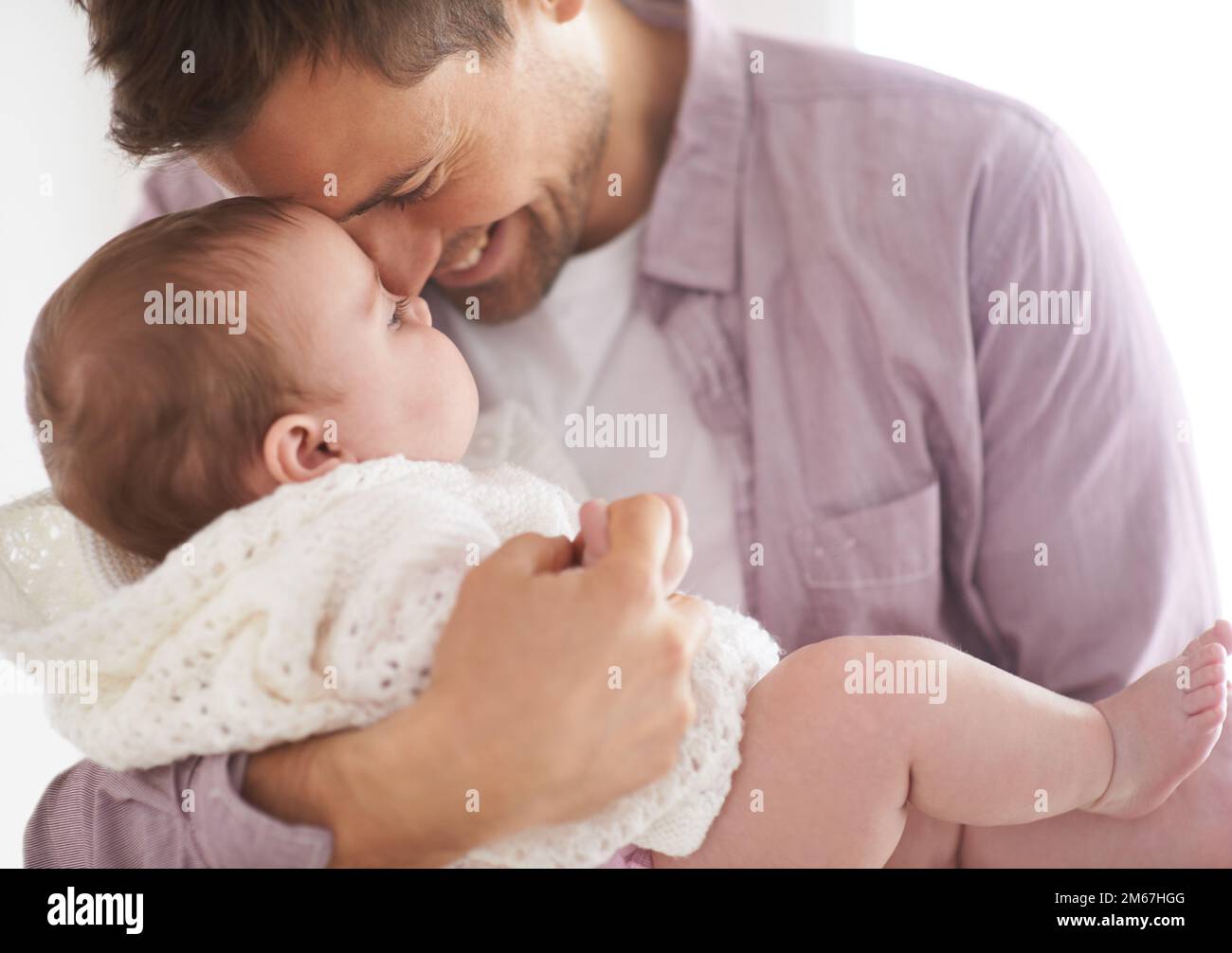 Hes a doting dad. a young father holding his adorable baby daughter and ...