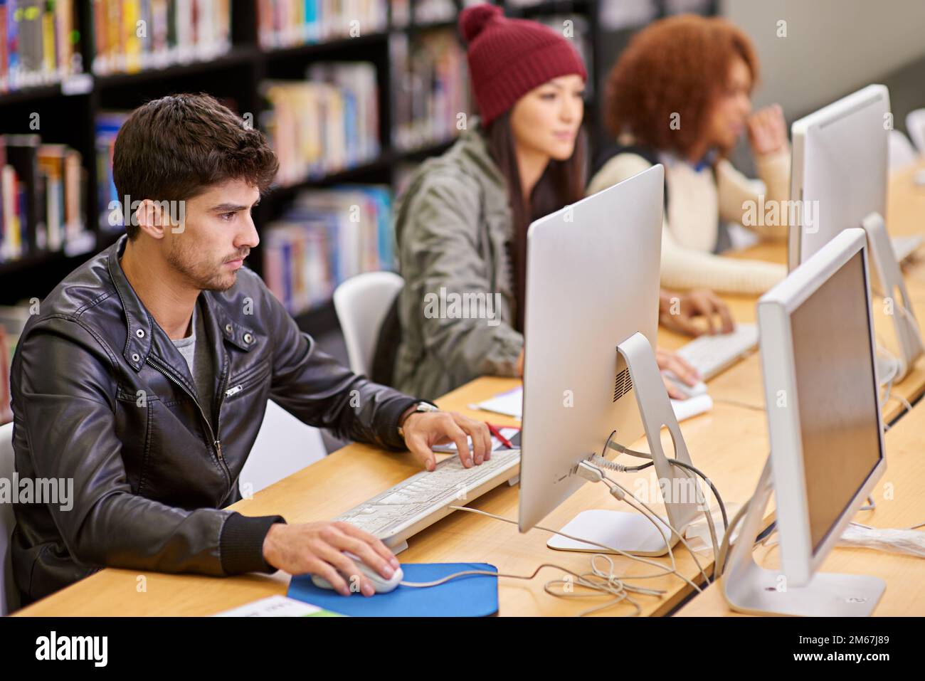 He takes his studies seriously. students working on computers in a university library Stock ...