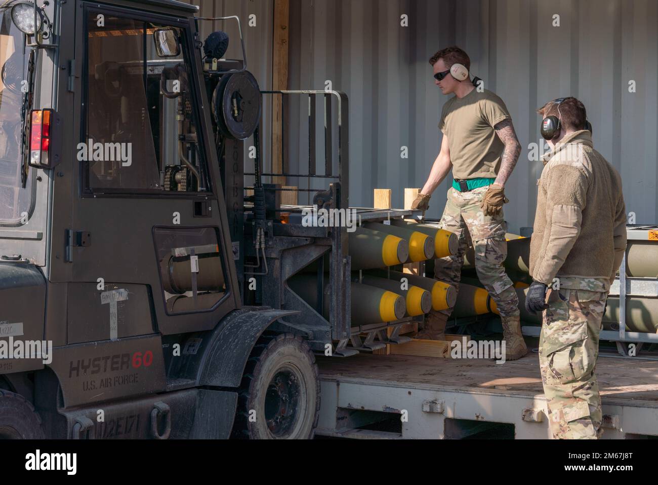 U.S. Air Force Airmen assigned to the 3rd Munitions Squadron unload a ...