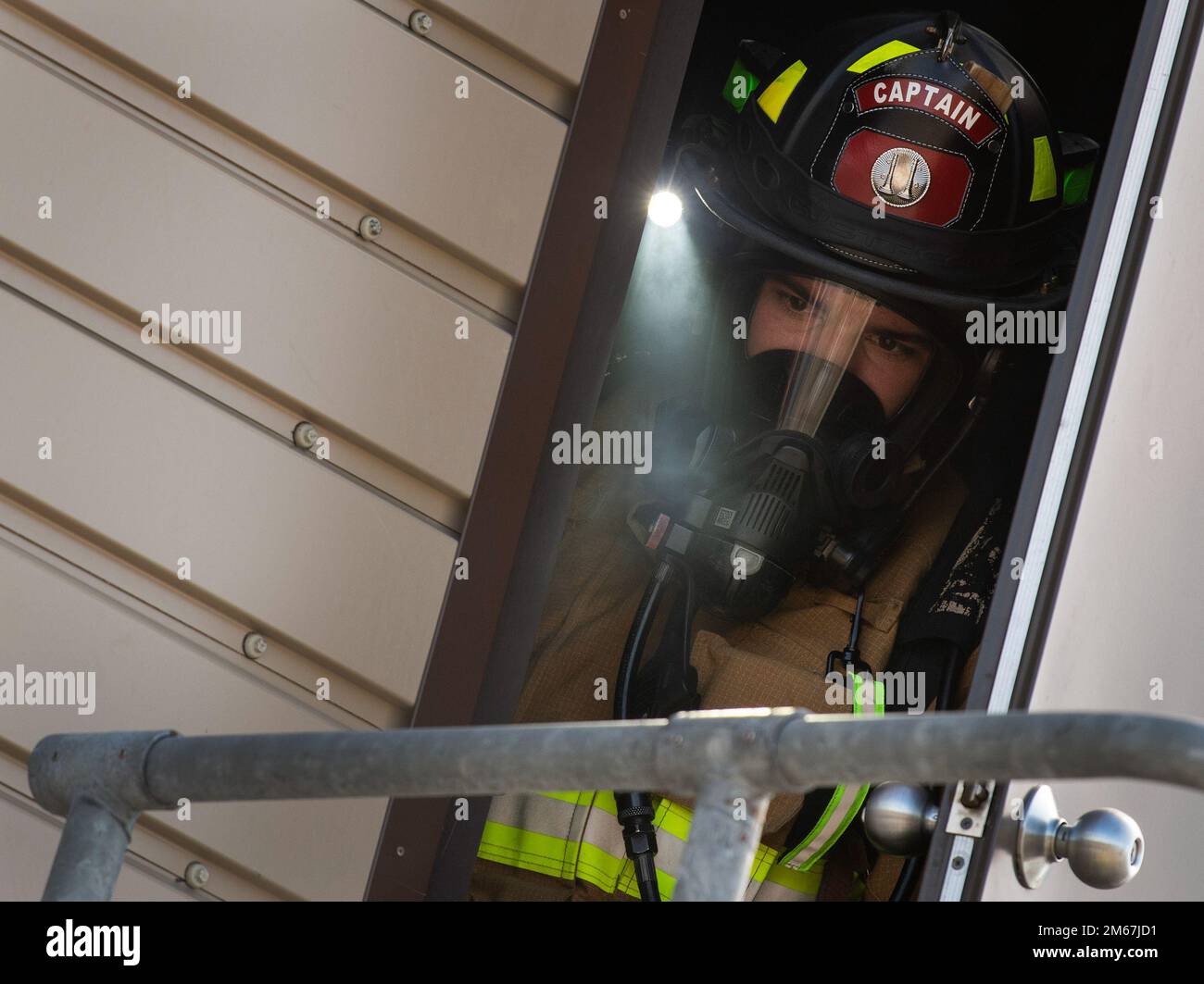 A 96th Civil Engineer Squadron firefighter opens a door during an ...