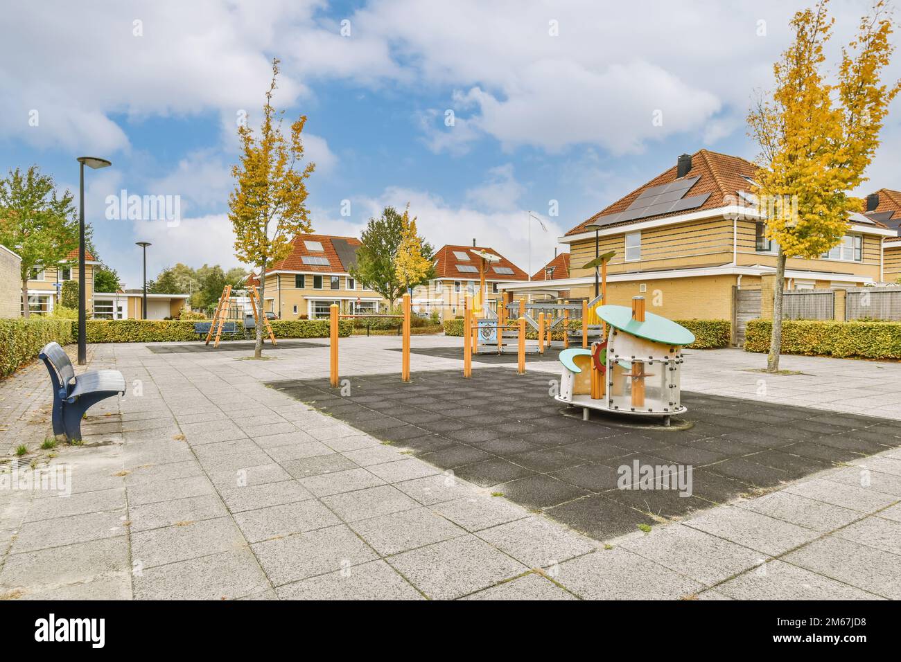 an empty playground in the middle of a residential area with yellow and ...