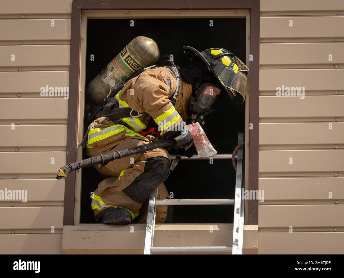 A 96th Civil Engineer Squadron firefighter climbs onto a ladder during ...