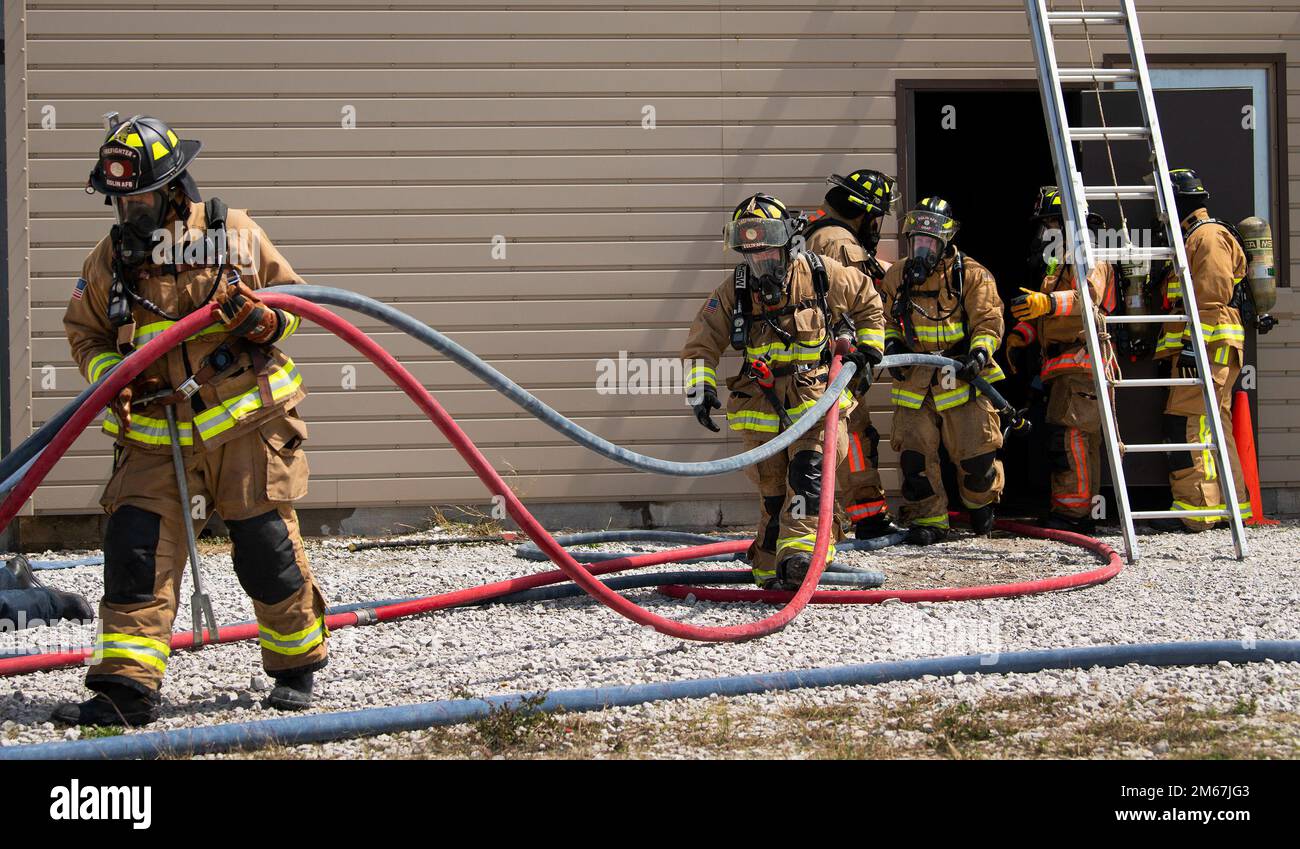 Firefighters from the 96th Civil Engineer Squadron, pulls fire hoses ...