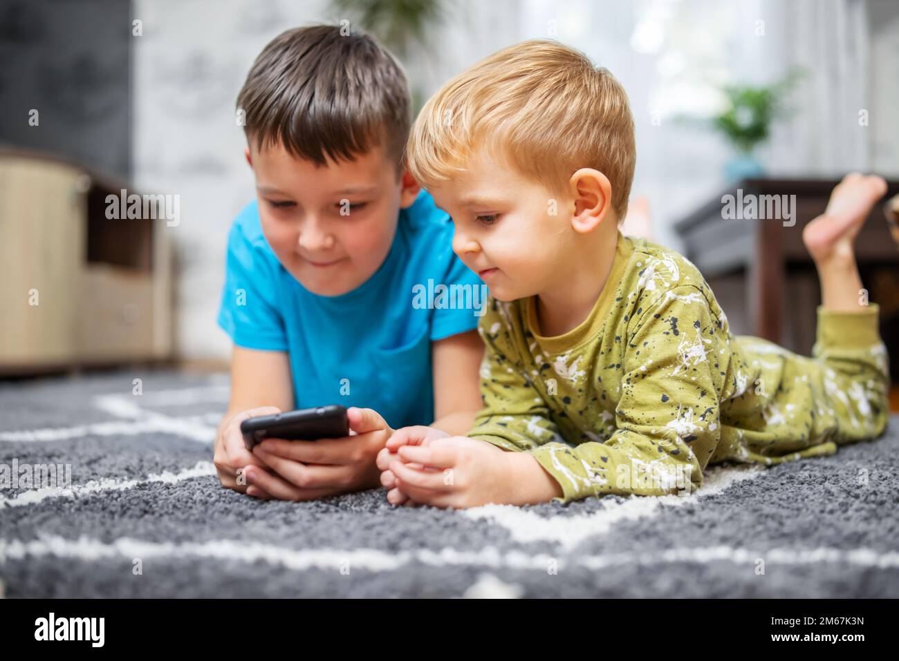 Two children watching smart phone, happy kids using smartphones ...