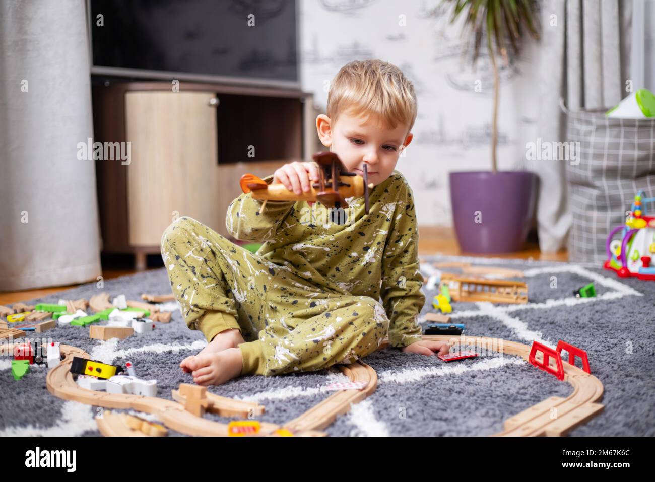 Happy child boy plays with toy airplane and dreams of becoming a pilot ...