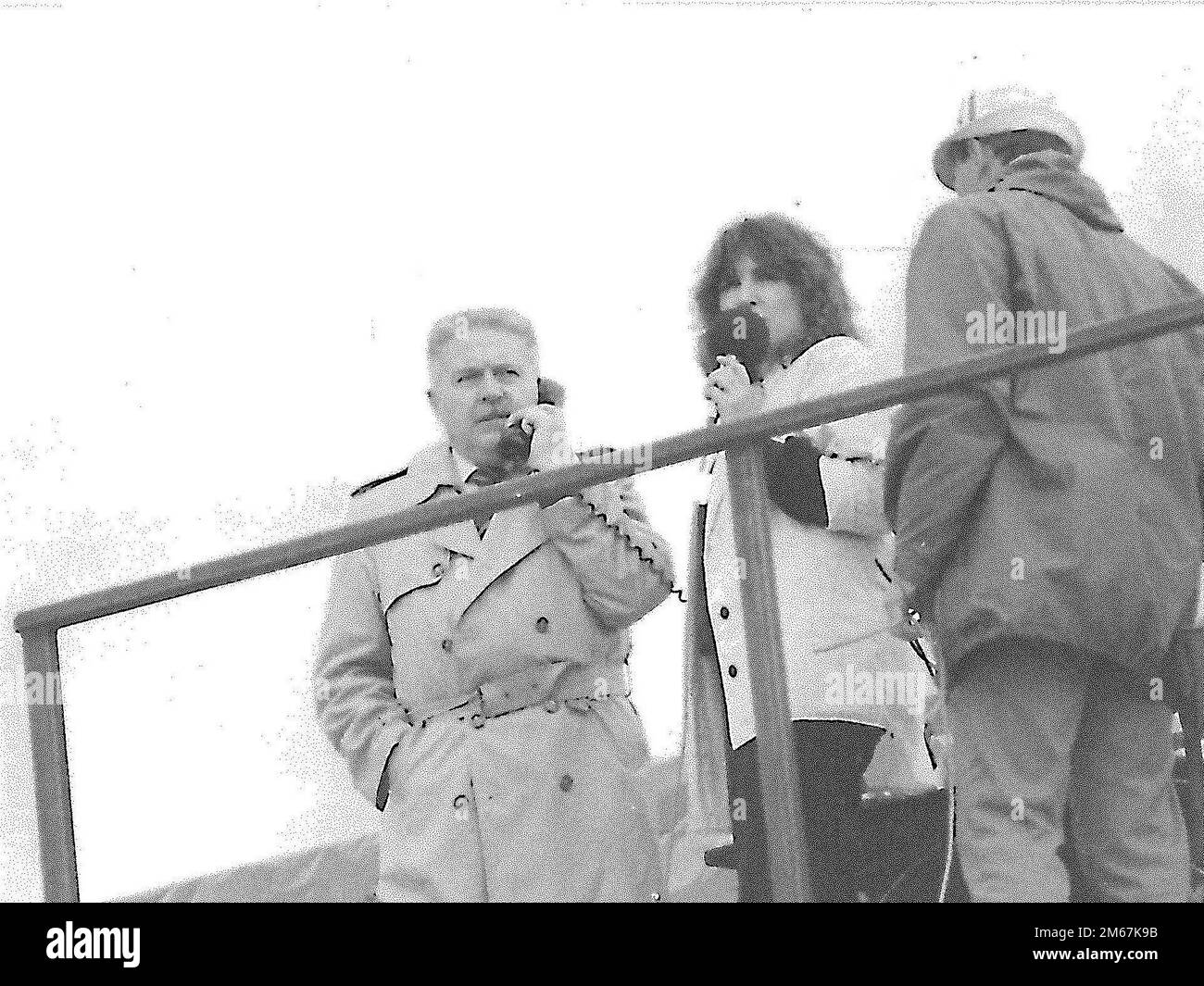 Charles Herbaut, left, talks on the phone, and Patricia Herbaut, middle ...