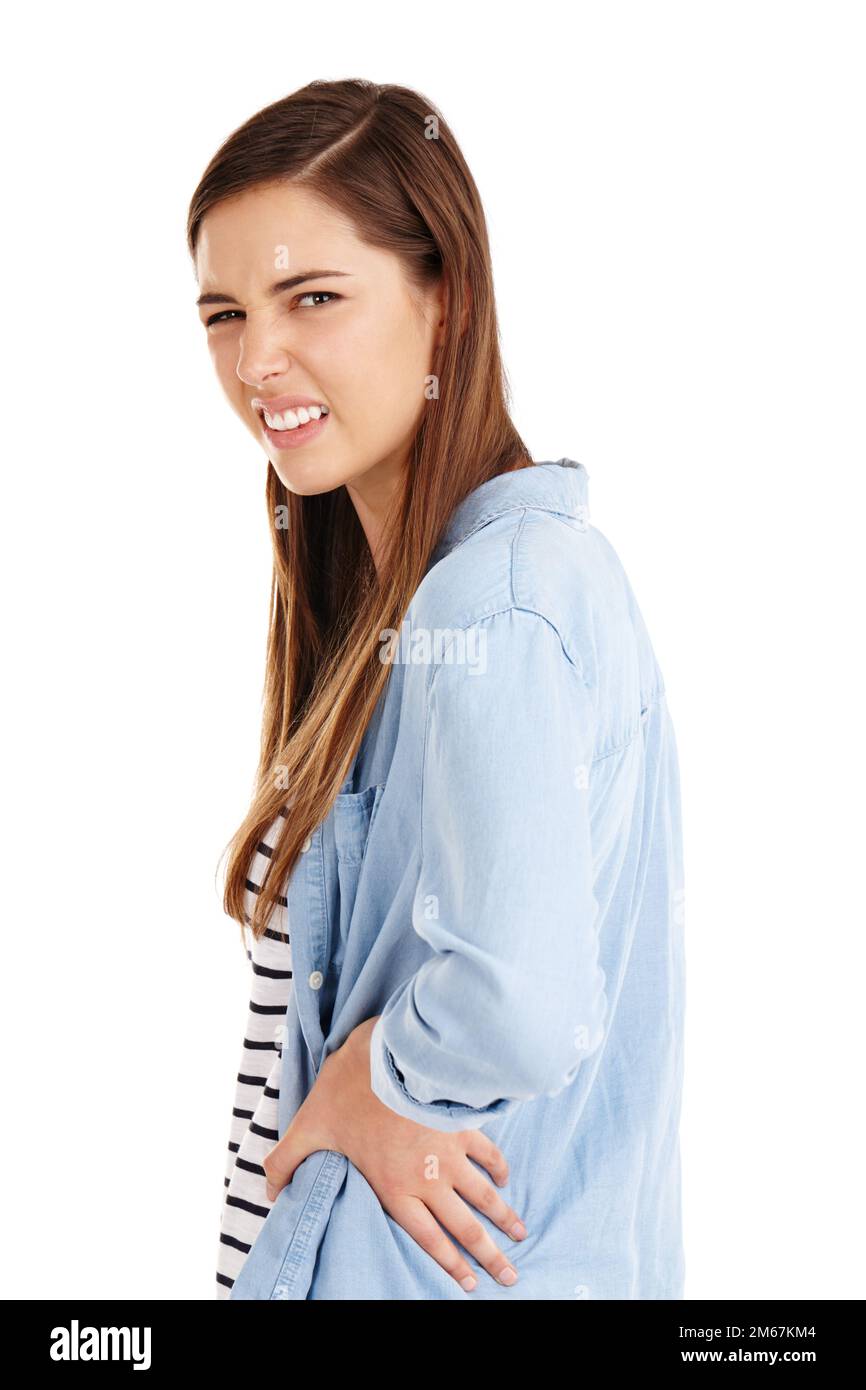 Backache can be such a pain. Studio shot of an attractive young woman ...