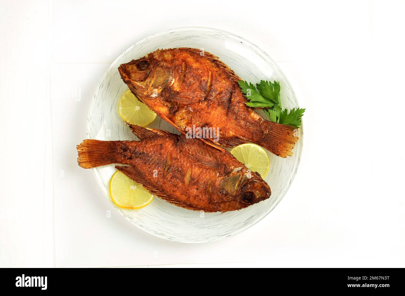 Popular Indonesian dish of fried fish isolated on white background ...