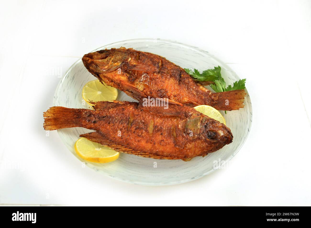 Popular Indonesian dish of fried fish isolated on white background ...