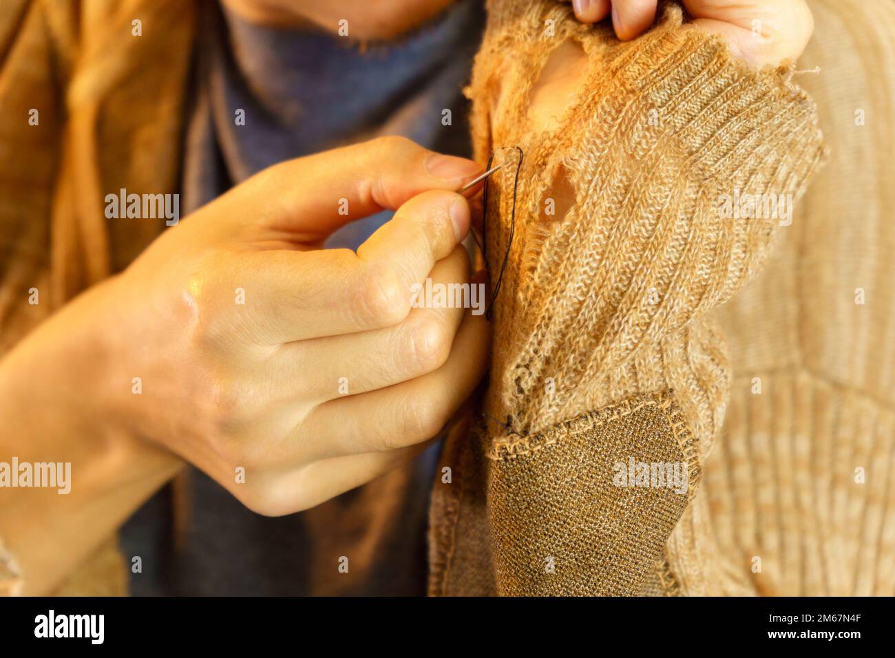 Mending clothes. Concept of mending and repairing clothes. Creative ...