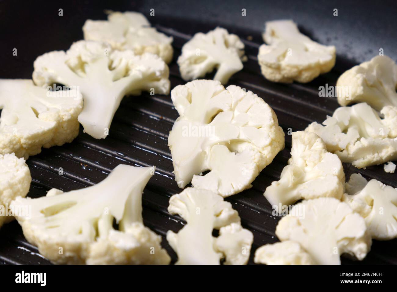 Cauliflower steaks cooking. Healthy eating, plant based meat substitute ...