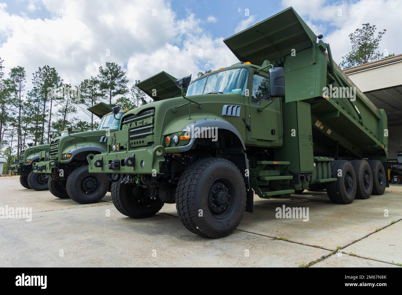 Three heavy dump trucks are staged and ready for handoff to the 289th ...