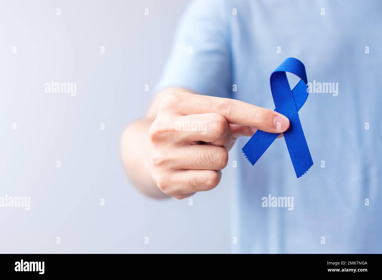 March Colorectal Cancer Awareness Month Woman Holding Dark Blue Ribbon