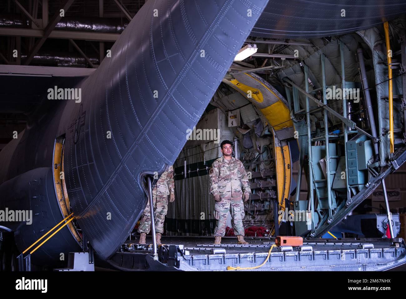 SrA Angel Reyes, a student in the Basic Loadmaster Course, prepares to direct cargo into the ...