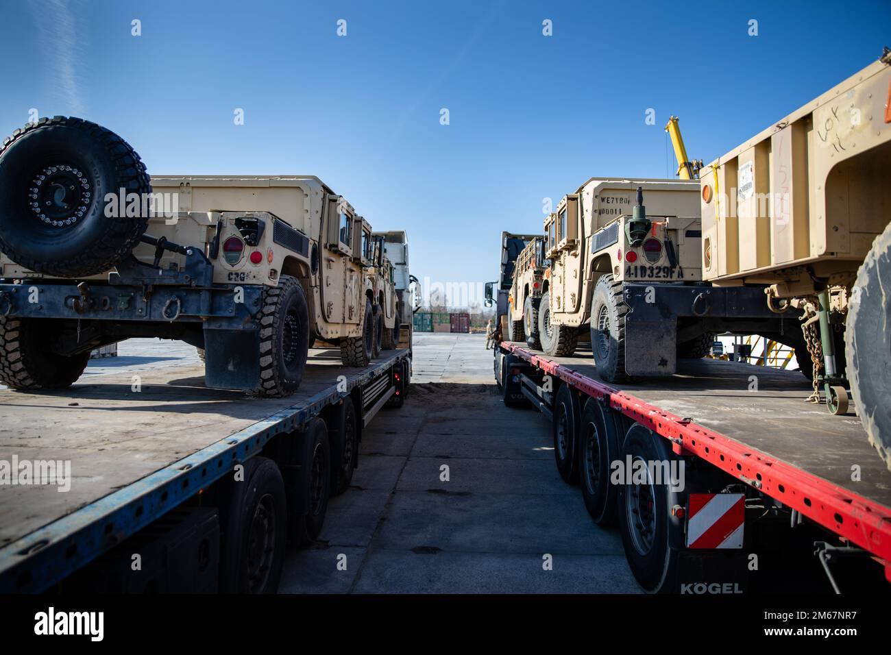 Two heavy load trucks transport U.S. Army high-mobility multipurpose ...