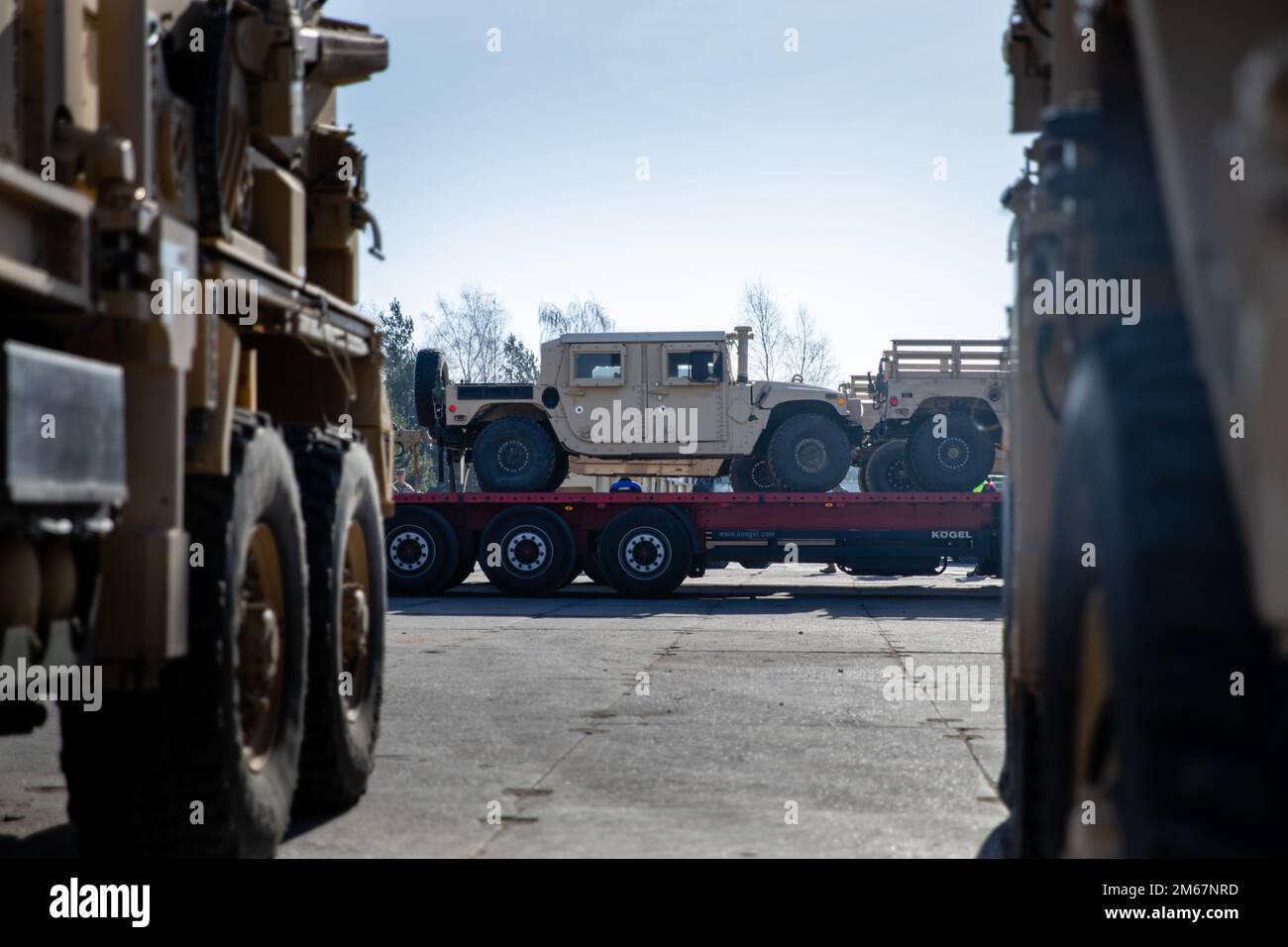 A heavy load truck transports U.S. Army high-mobility multipurpose ...