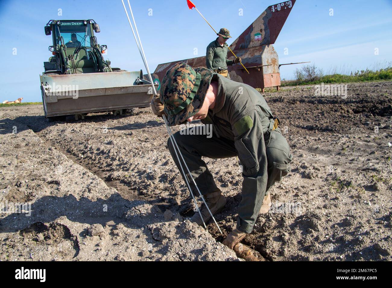 U.S. Marine Corps Staff Sgt. Leon Nevins (center) and Staff Sgt. Dent ...