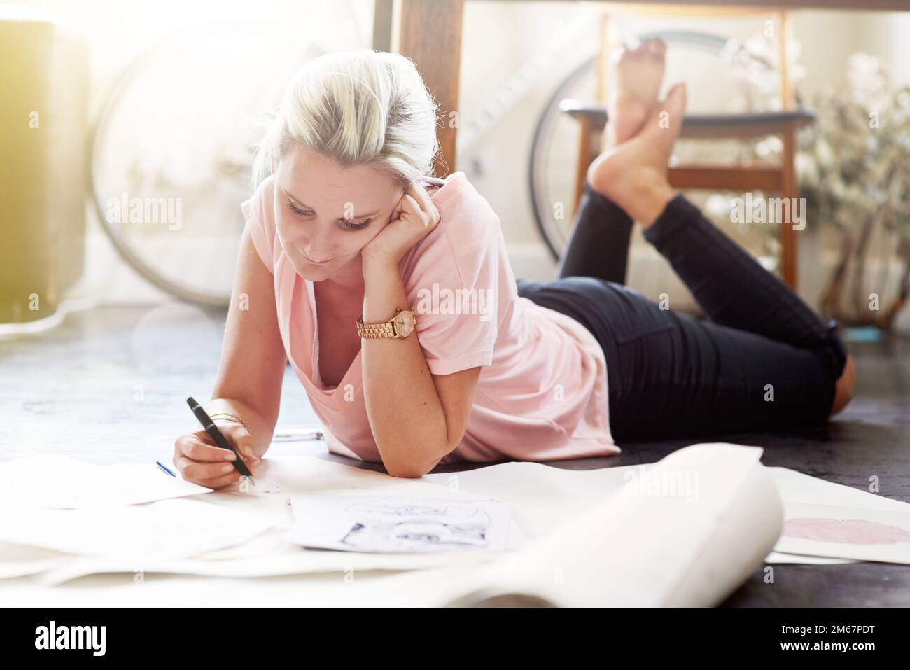 Working on some concept art. a female graphic artist working on ...