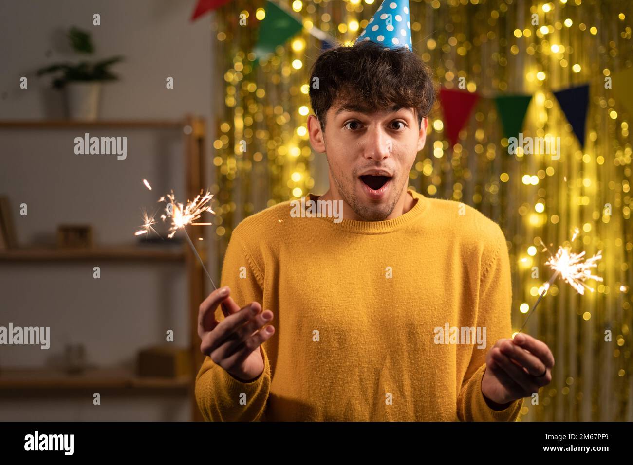 Good looking man looking surprisely into camera, realizing that party ...
