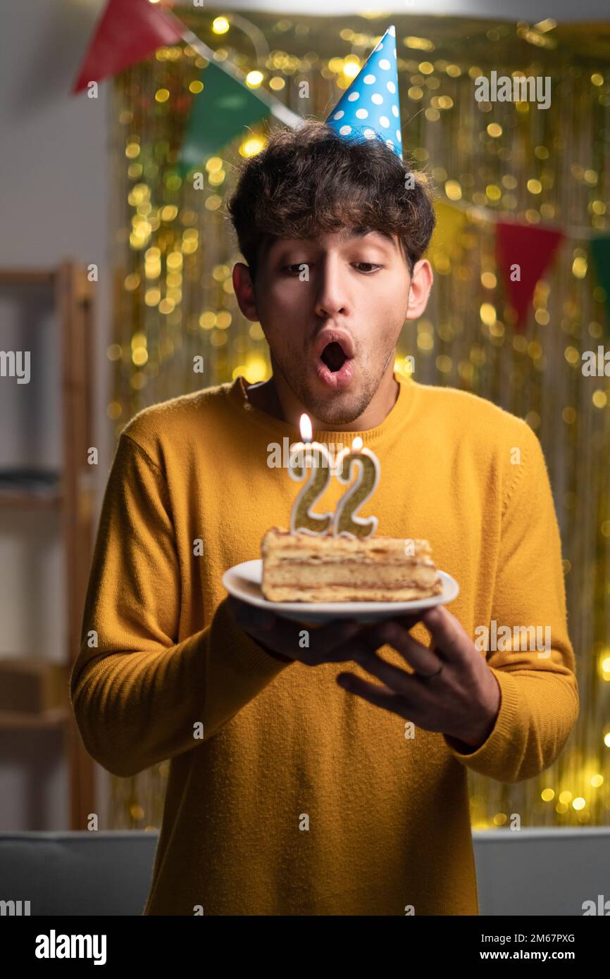 Holidays and celebration. Excited young man celebrating 22th birthday ...