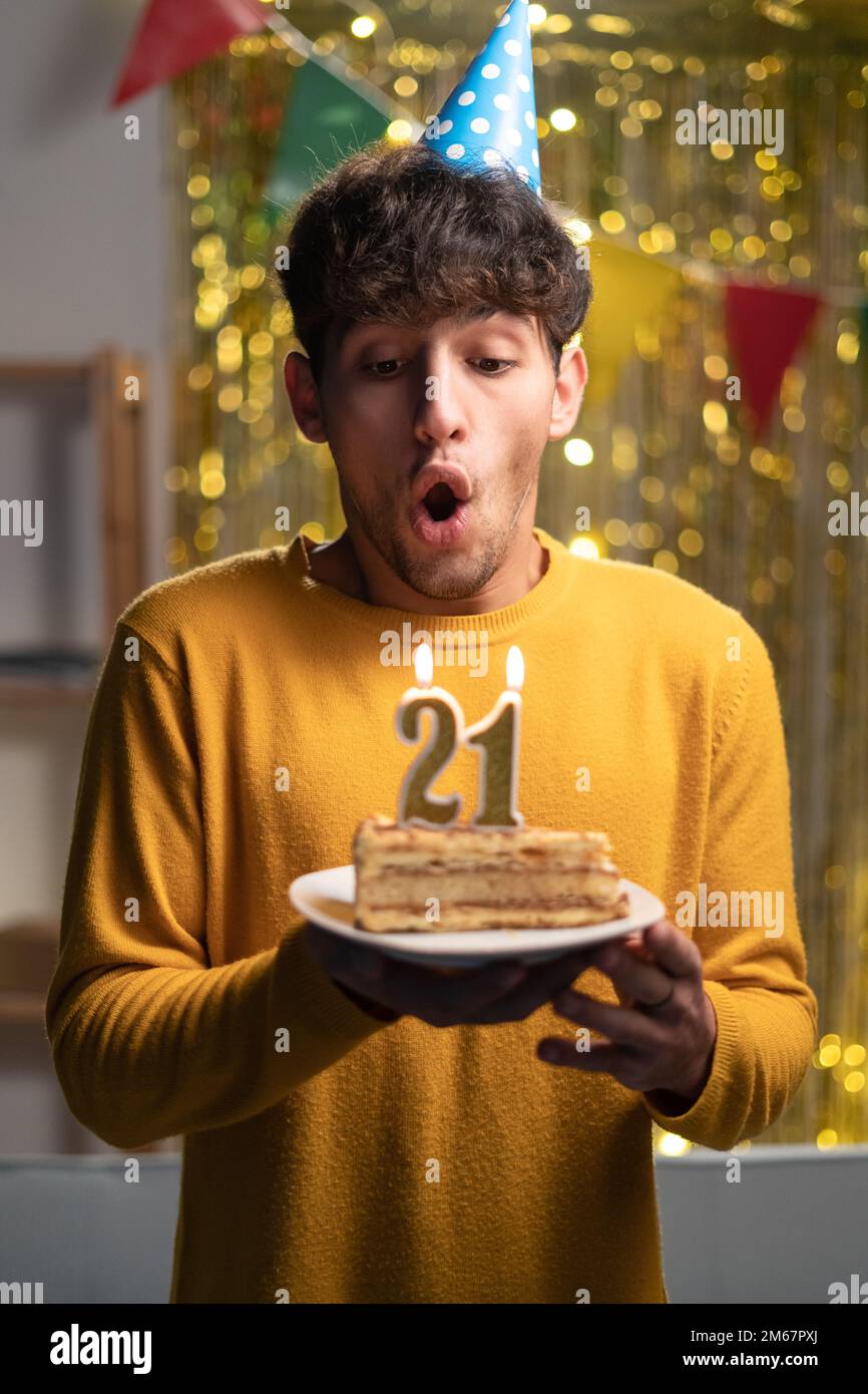 Holidays and celebration. Excited young man celebrating 21th birthday ...