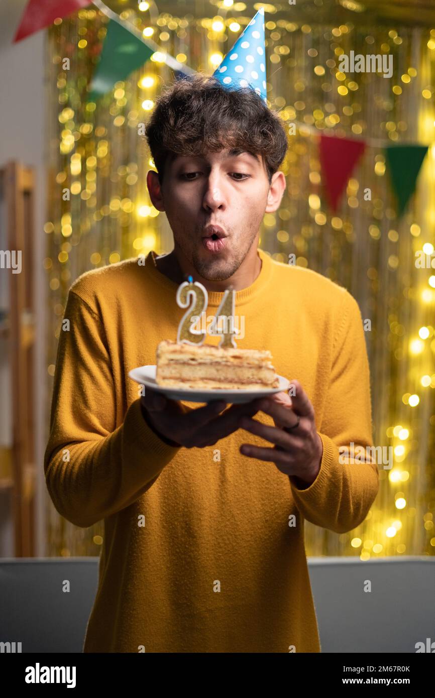 Holidays and celebration. Excited young man celebrating 24th birthday ...